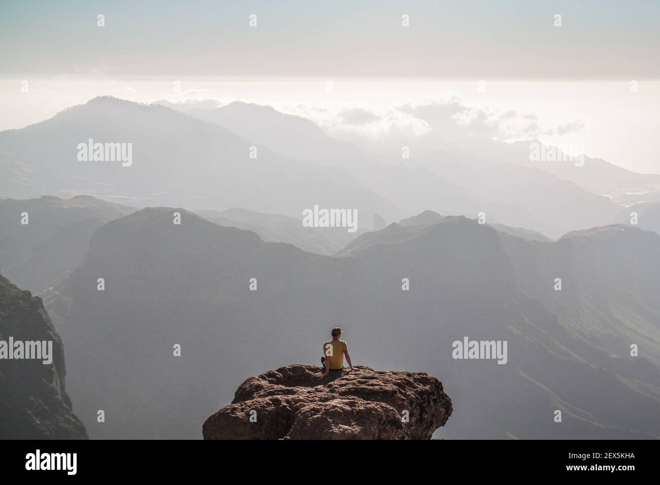 Big cliff and man sit hi-res stock photography and images - Alamy