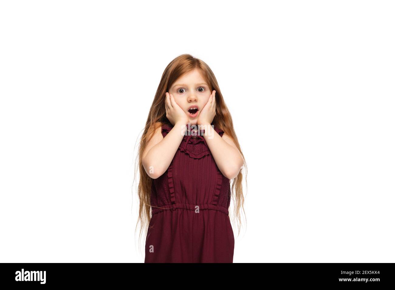 Shy, astonished. Happy, smiley little caucasian girl isolated on white ...