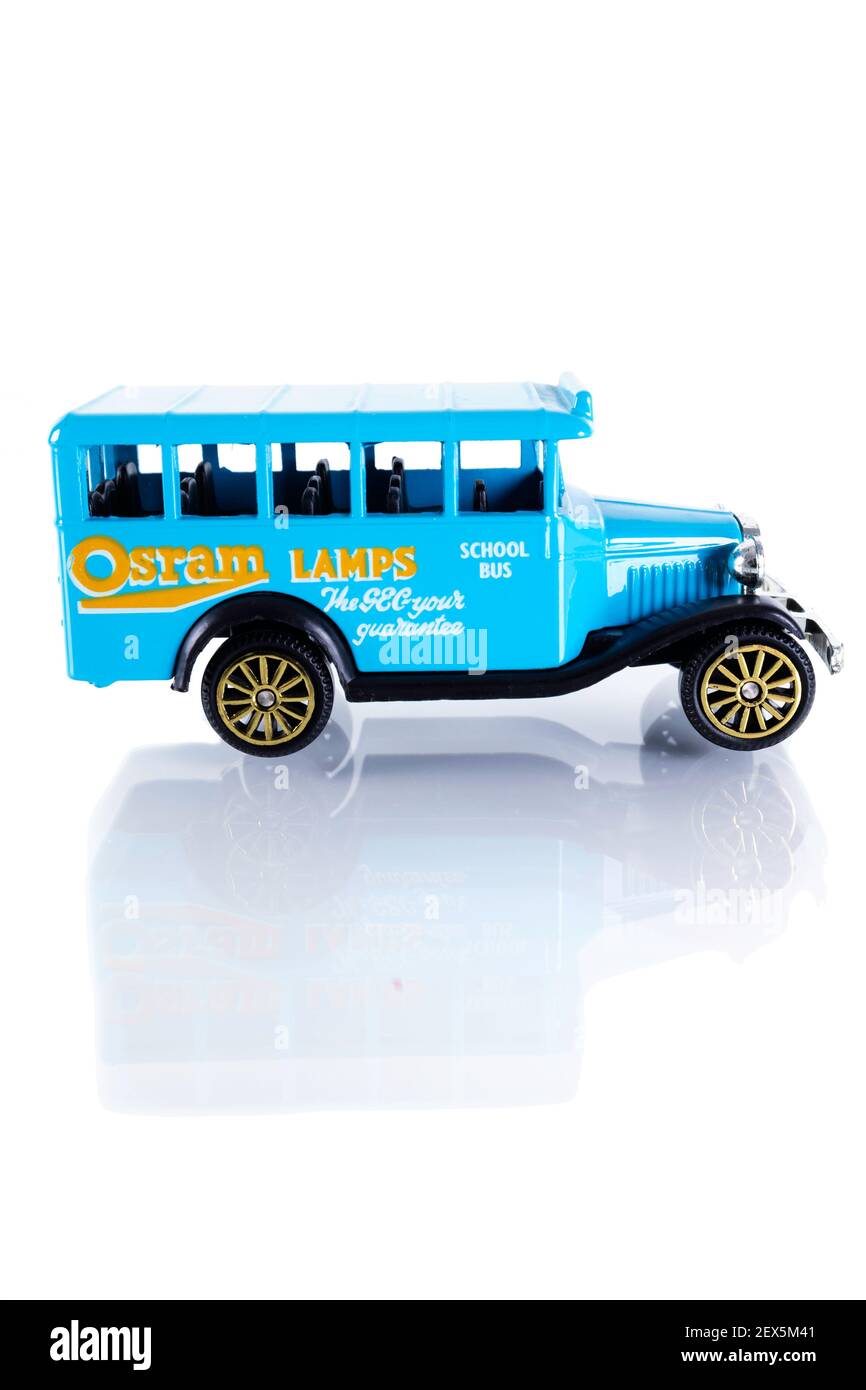 Worn diecast model of a vintage 'Osram Lamps' school bus. Isolated on a ...