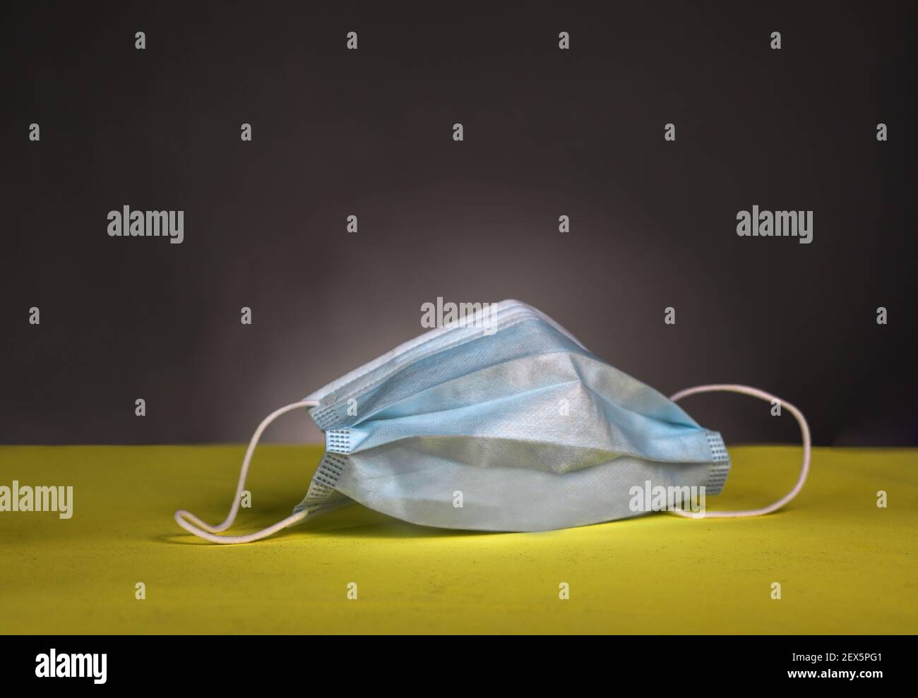 Medical protective masks on yellow and gray background. Disposable ...