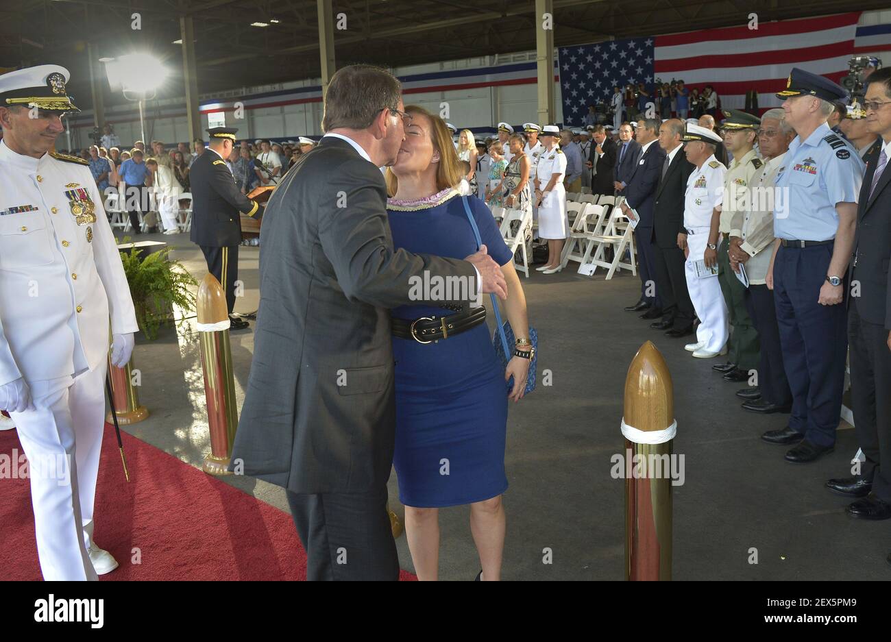 Secretary of Defense Ash Carter offers a kiss to his wife Stephanie as ...