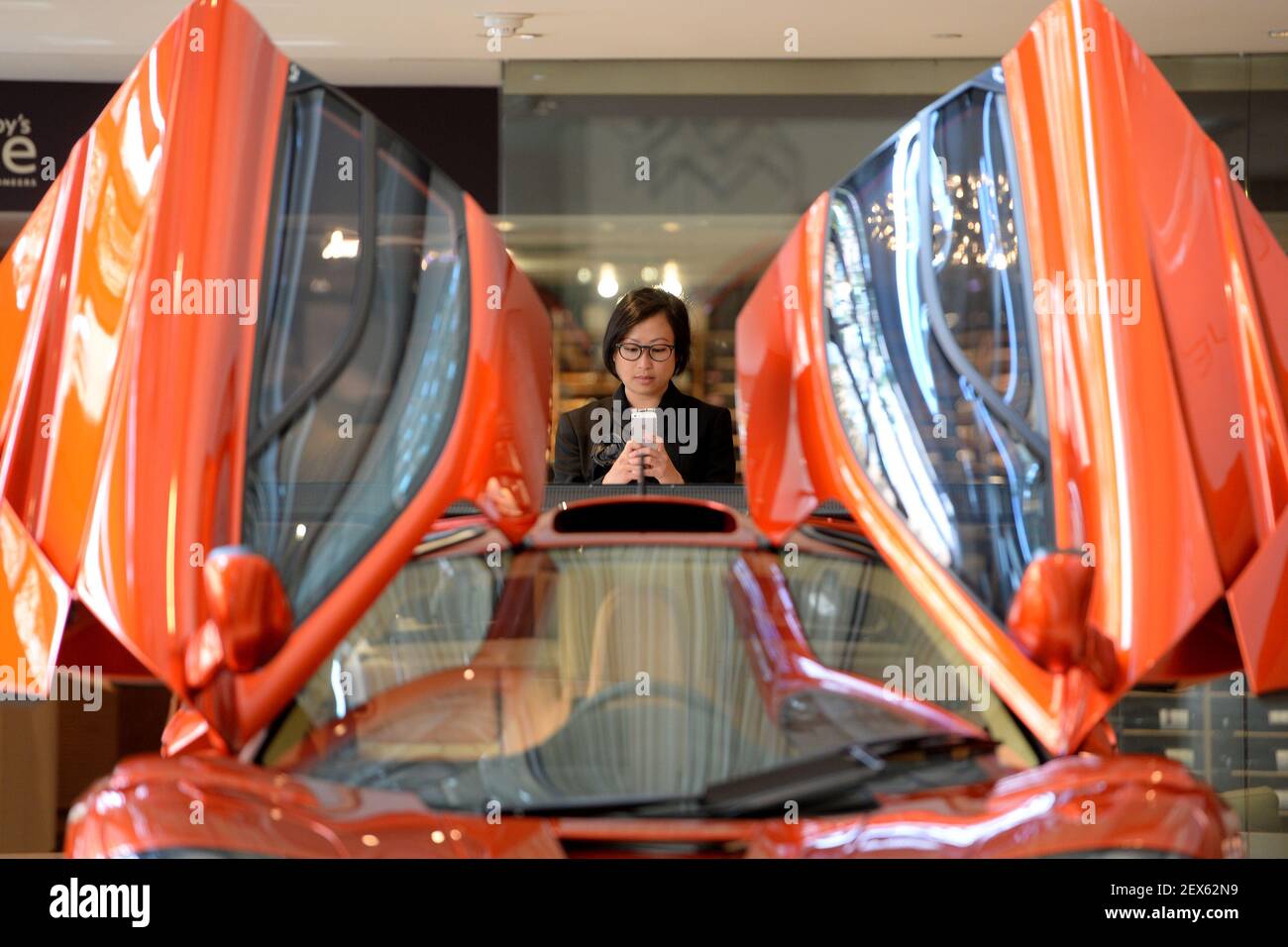 Michelle Tay uses her smartphone to photograph a 1998 McLaren F1 "LM ...