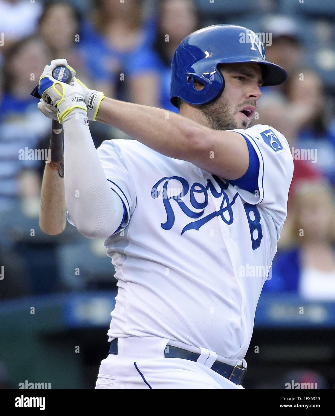 The Kansas City Royals' Mike Moustakas follows through on an RBI single ...