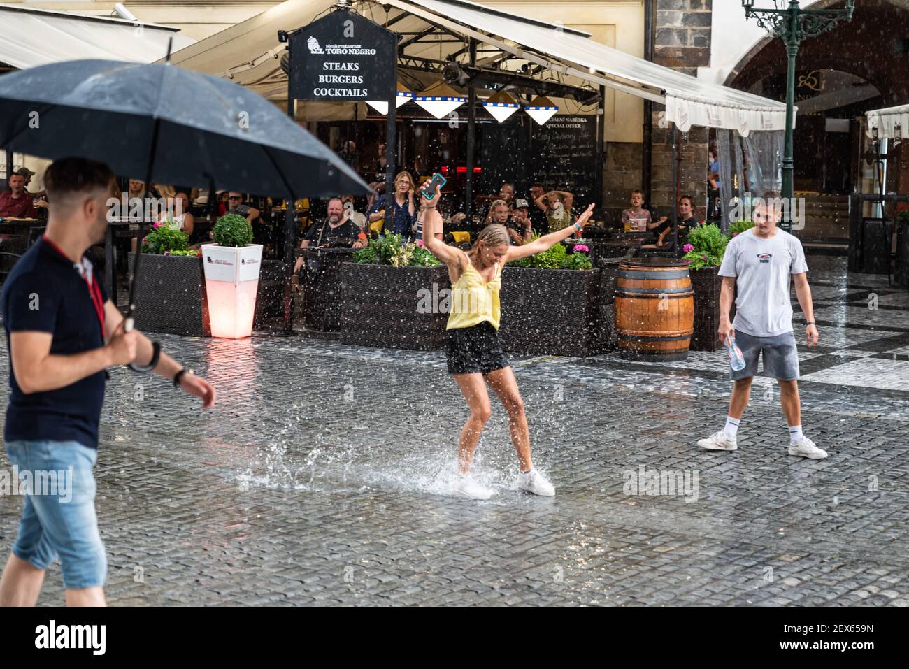 Playful woman splashing puddle water hi-res stock photography and ...
