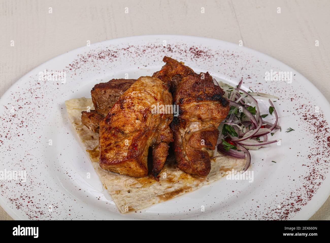 Grilled pork ribs shashlik barbeque served onion Stock Photo - Alamy