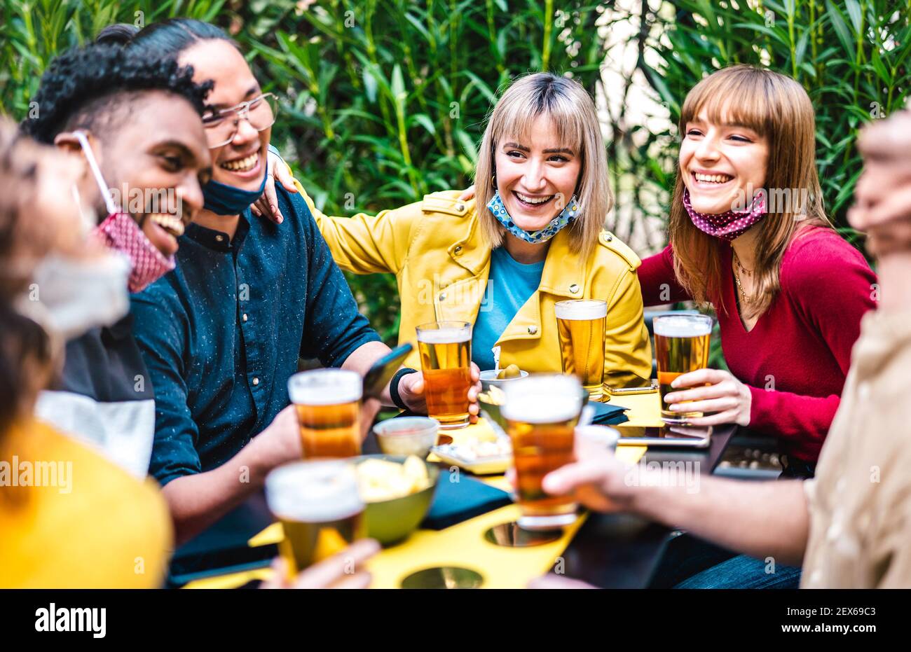 Multiracial people drinking beer with opened face mask - New normal ...