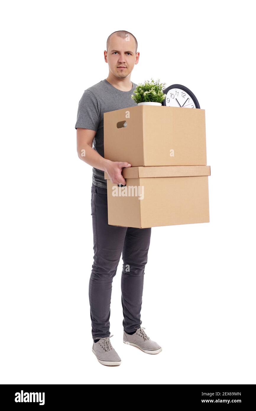 moving day concept - full length portrait of young man with boxes ...