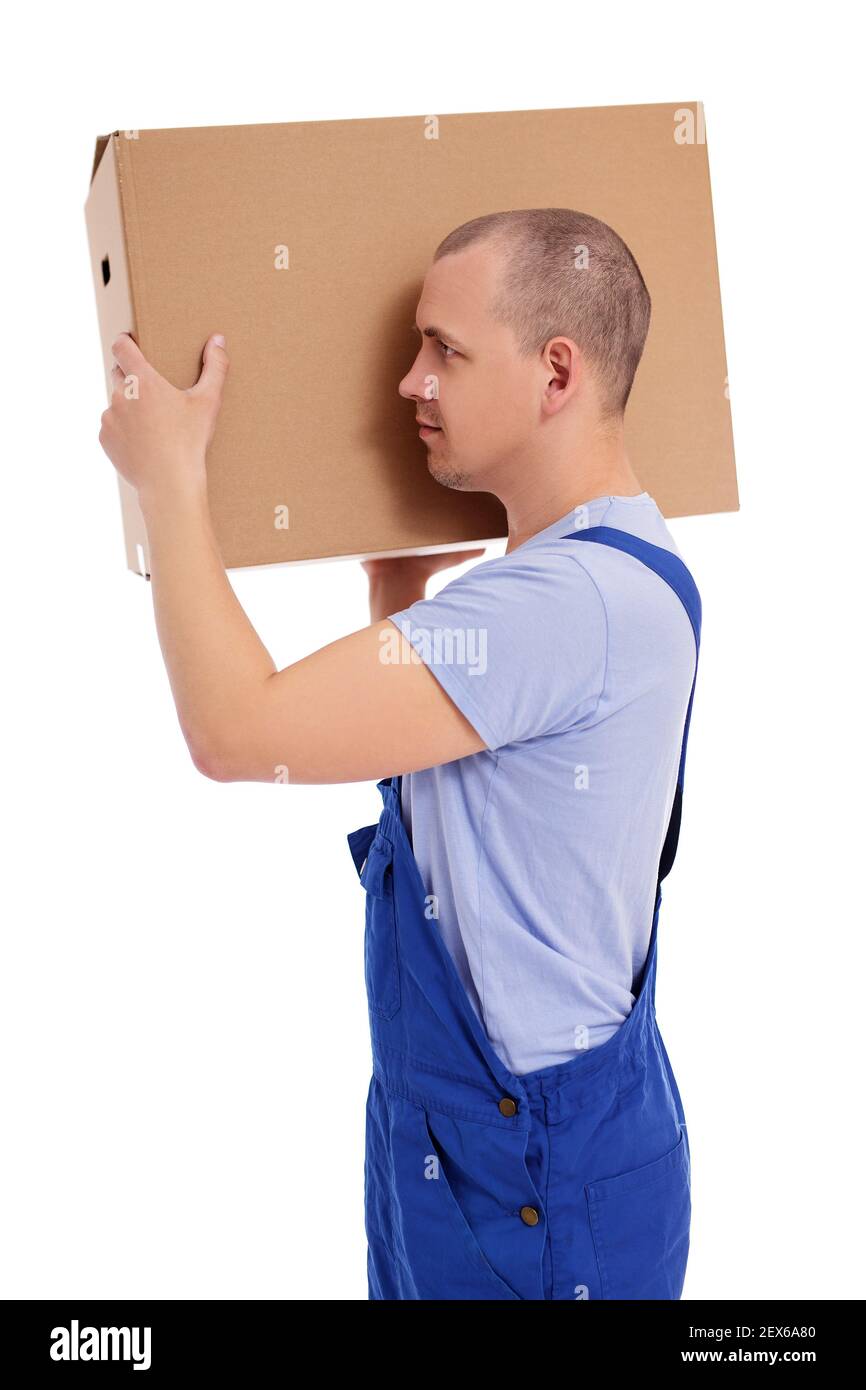 side view of man loader in uniform with big box on his shoulder ...