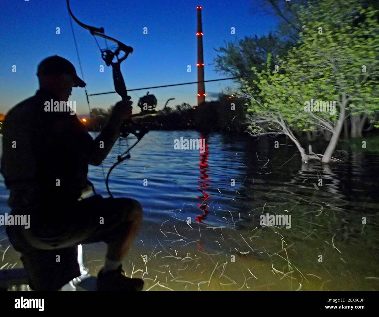 Bowfisherman Mark Ellenberg cruises the St. Croix River shallows near ...