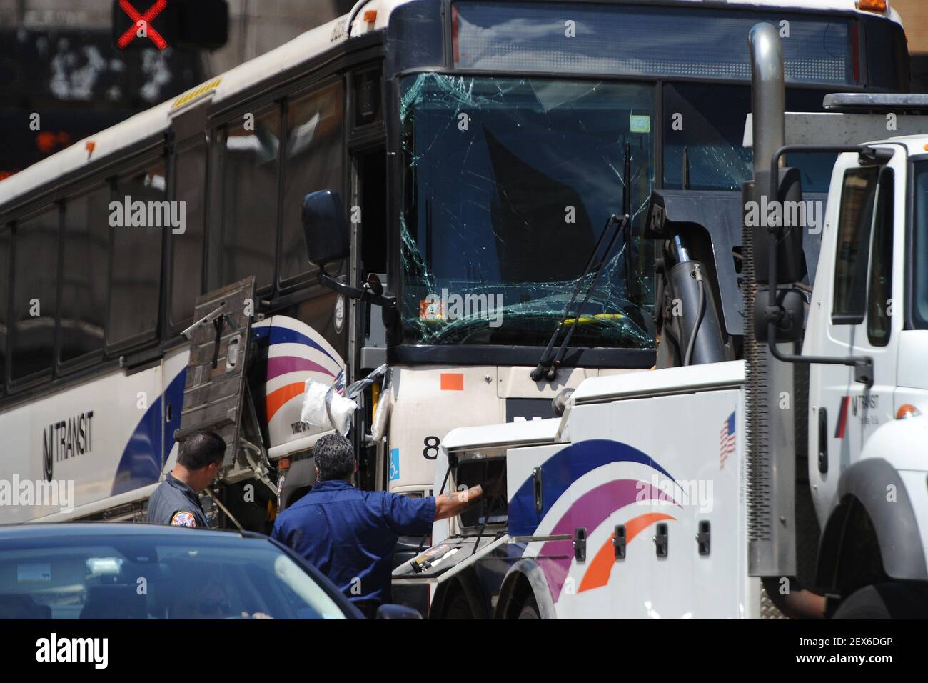 One of two buses with a smashed windscreen sits at the Manhattan side ...