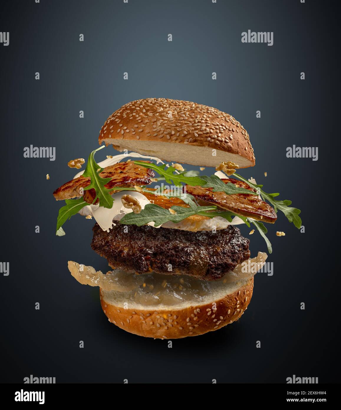Big tasty hamburger with flying elements. Floating beef burger with ...