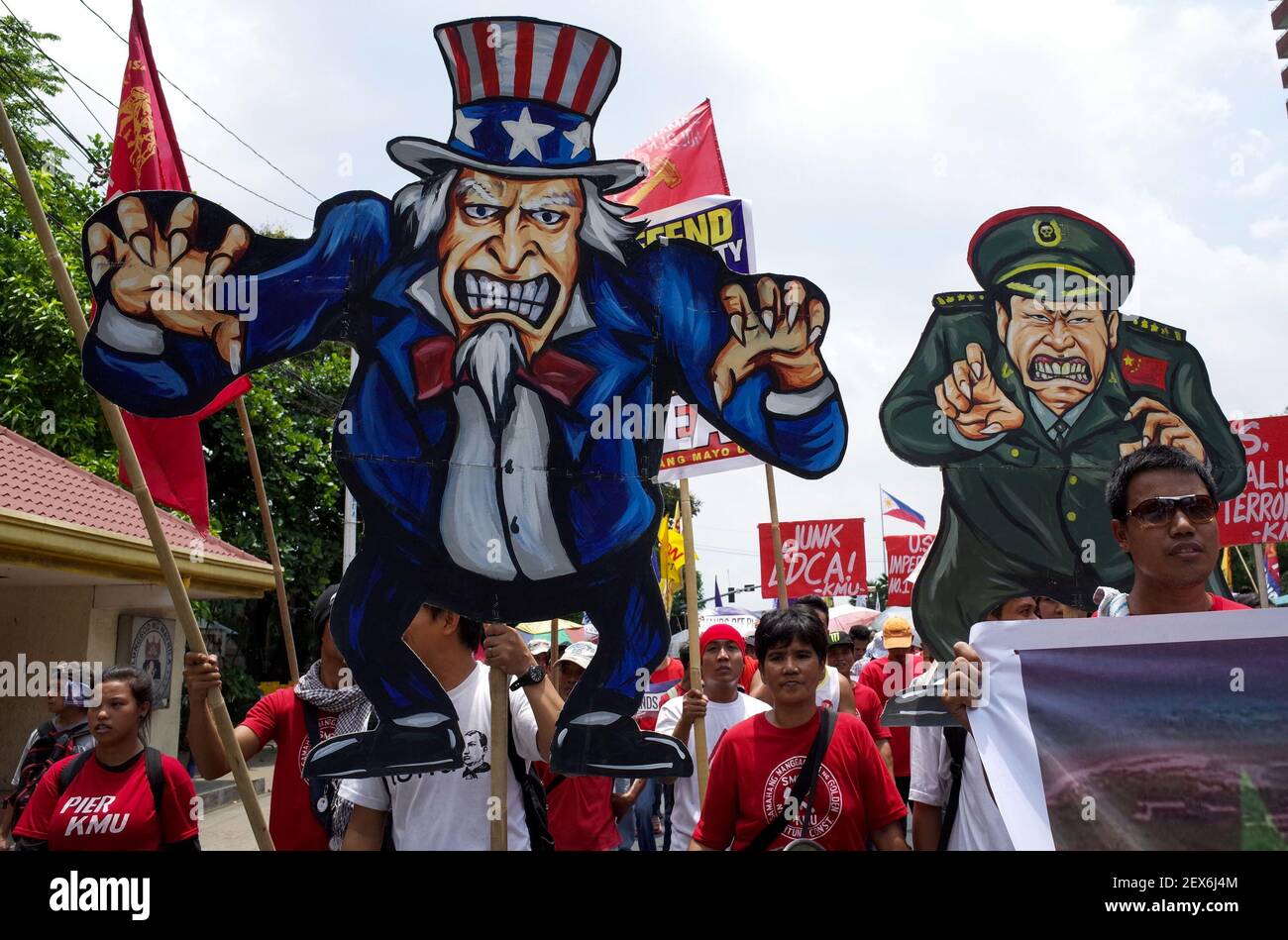 Protesters hold cutouts of the proverbial Uncle Sam and a Chinese ...