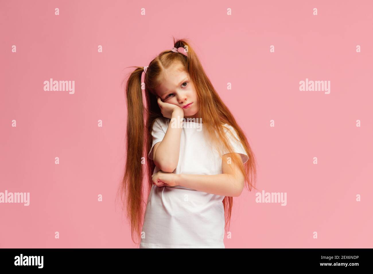 Bored, desponded. Happy, smiley little caucasian girl isolated on pink ...