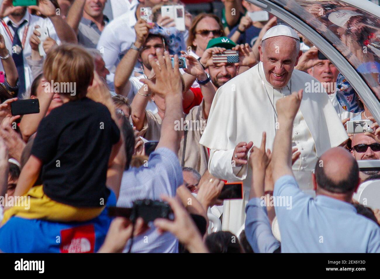 Pope Francis greets people during his official visit to the Exposition ...
