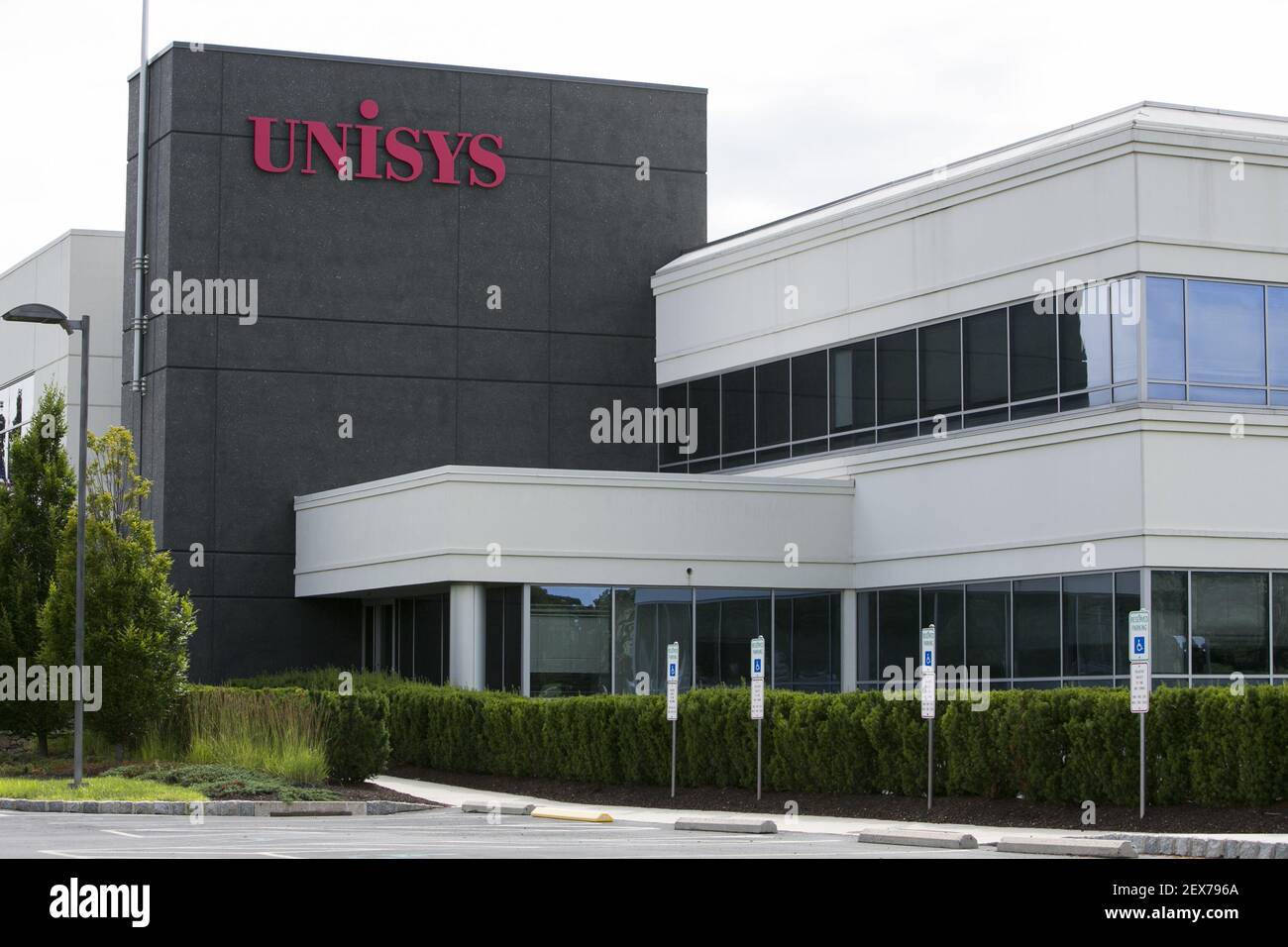 A logo sign outside of the headquarters of Unisys Corporation in Blue ...