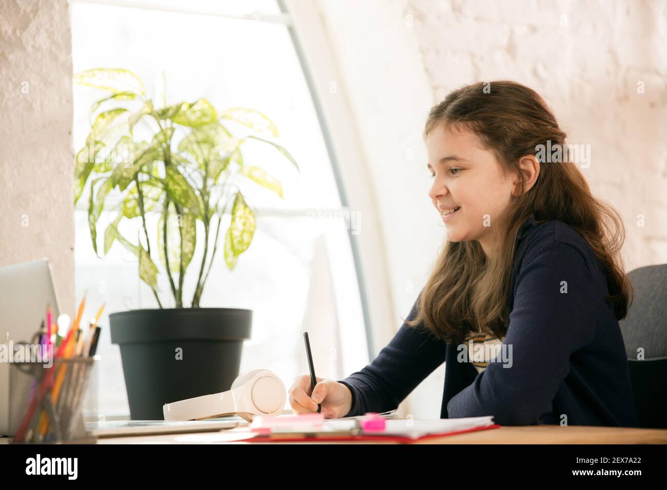 Little girl studying by group video call, use video conference with ...