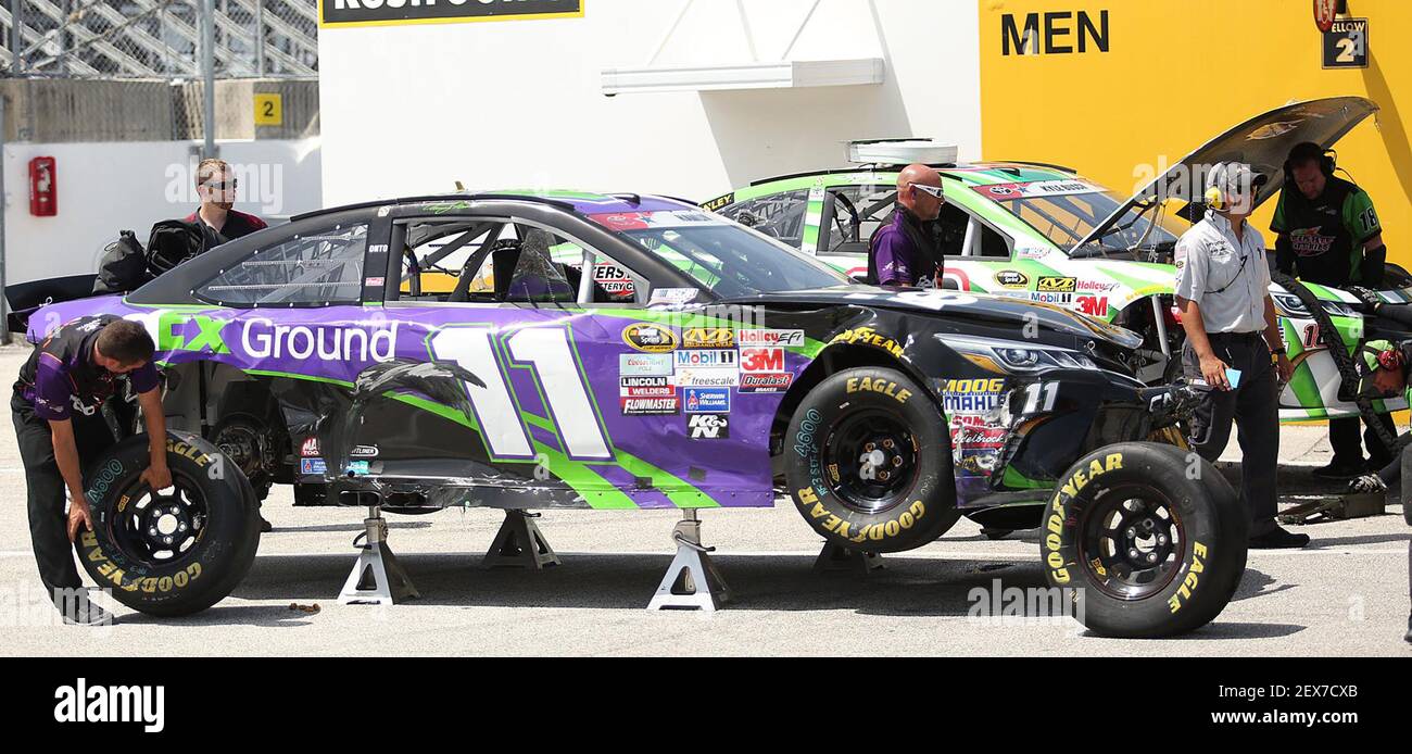 The crews of Denny Hamlin (11) and Kyle Busch (18) work on their ...