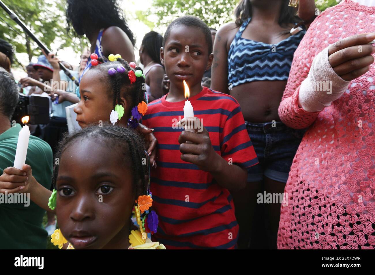 People attend a aandlelight vigil for seven-year-old victim Amari Brown ...