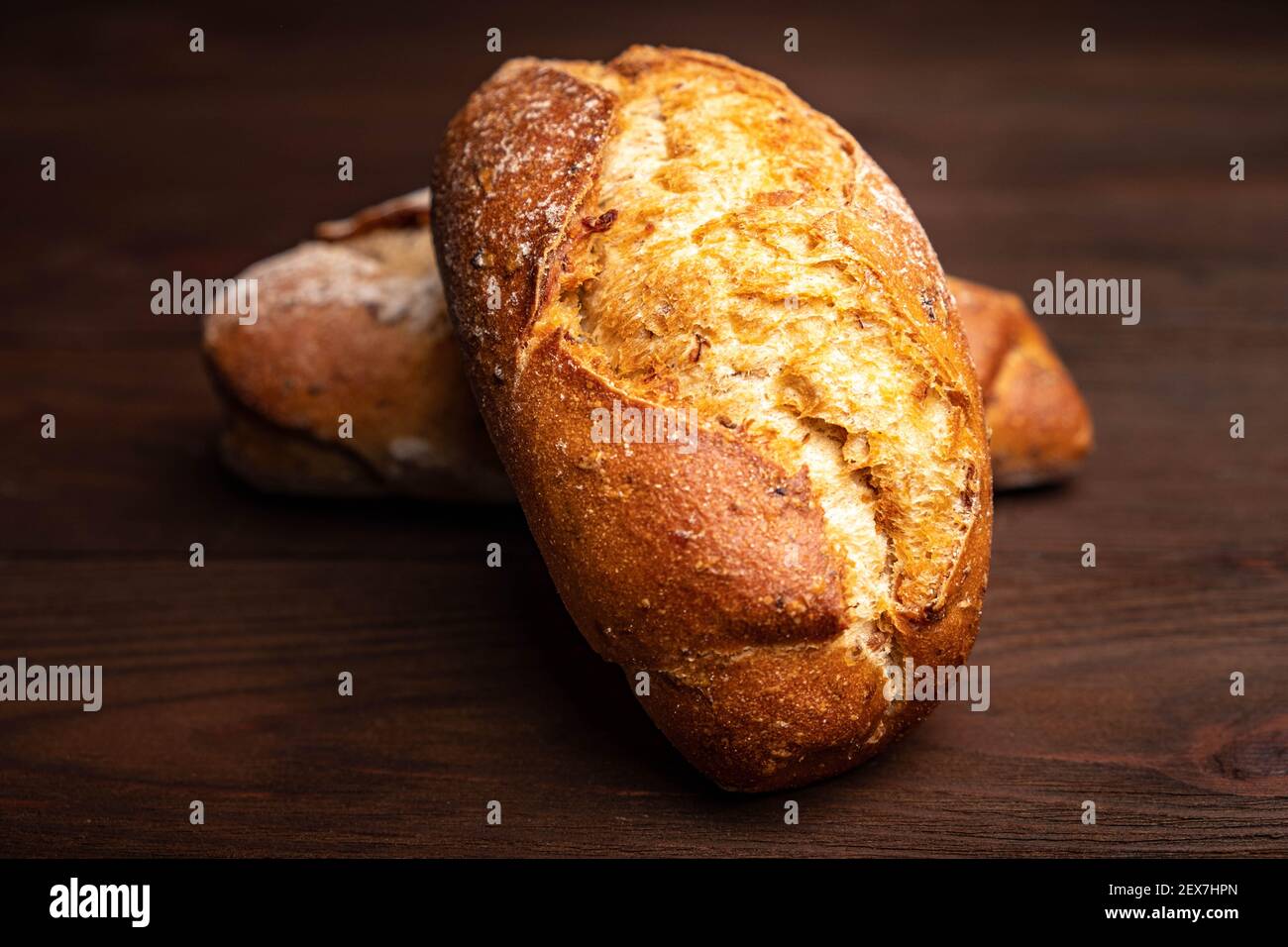 Wheat bread on wooden background Stock Photo - Alamy