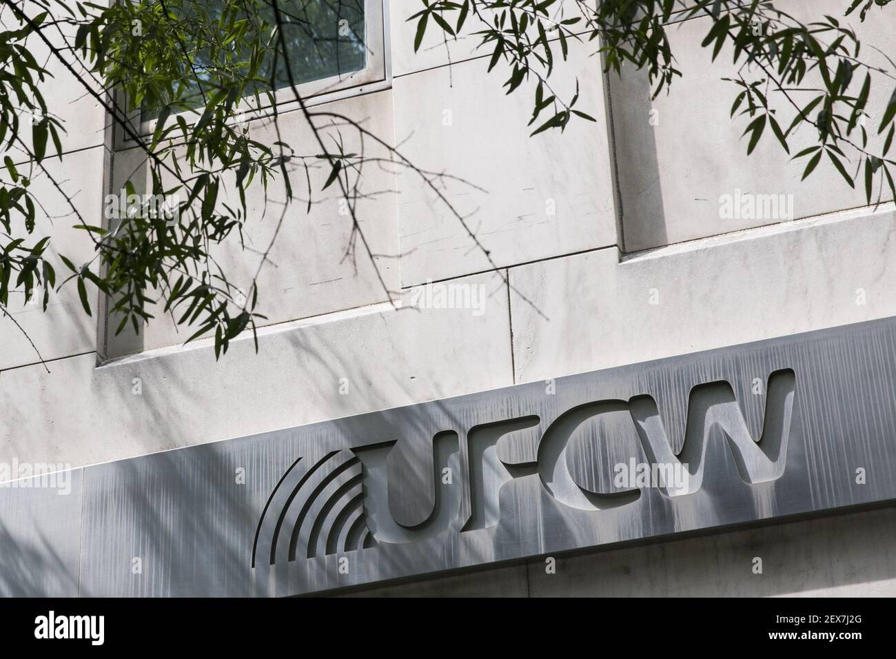 A logo sign outside of the headquarters of the United Food and ...