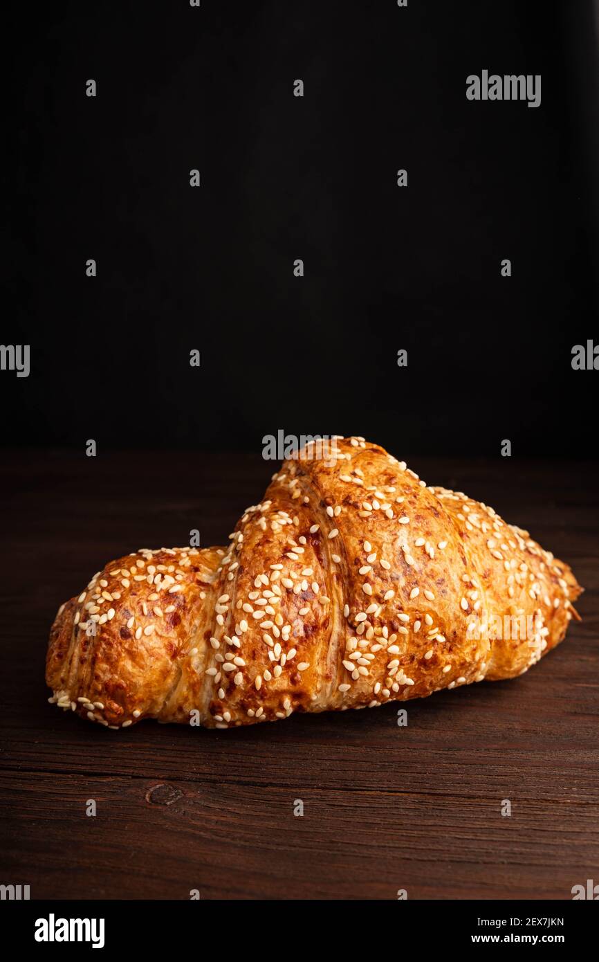 Croissant with sesame seeds isolated on a wooden background Stock Photo ...