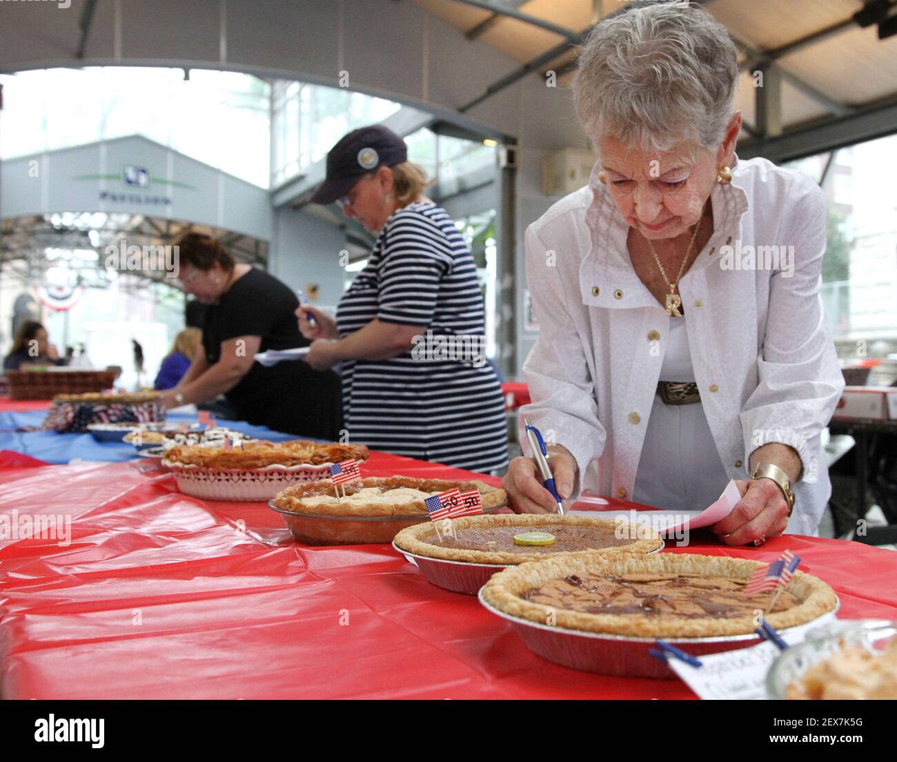 Pie judge Judy Taylor writes down her scores during Lexington's annual ...