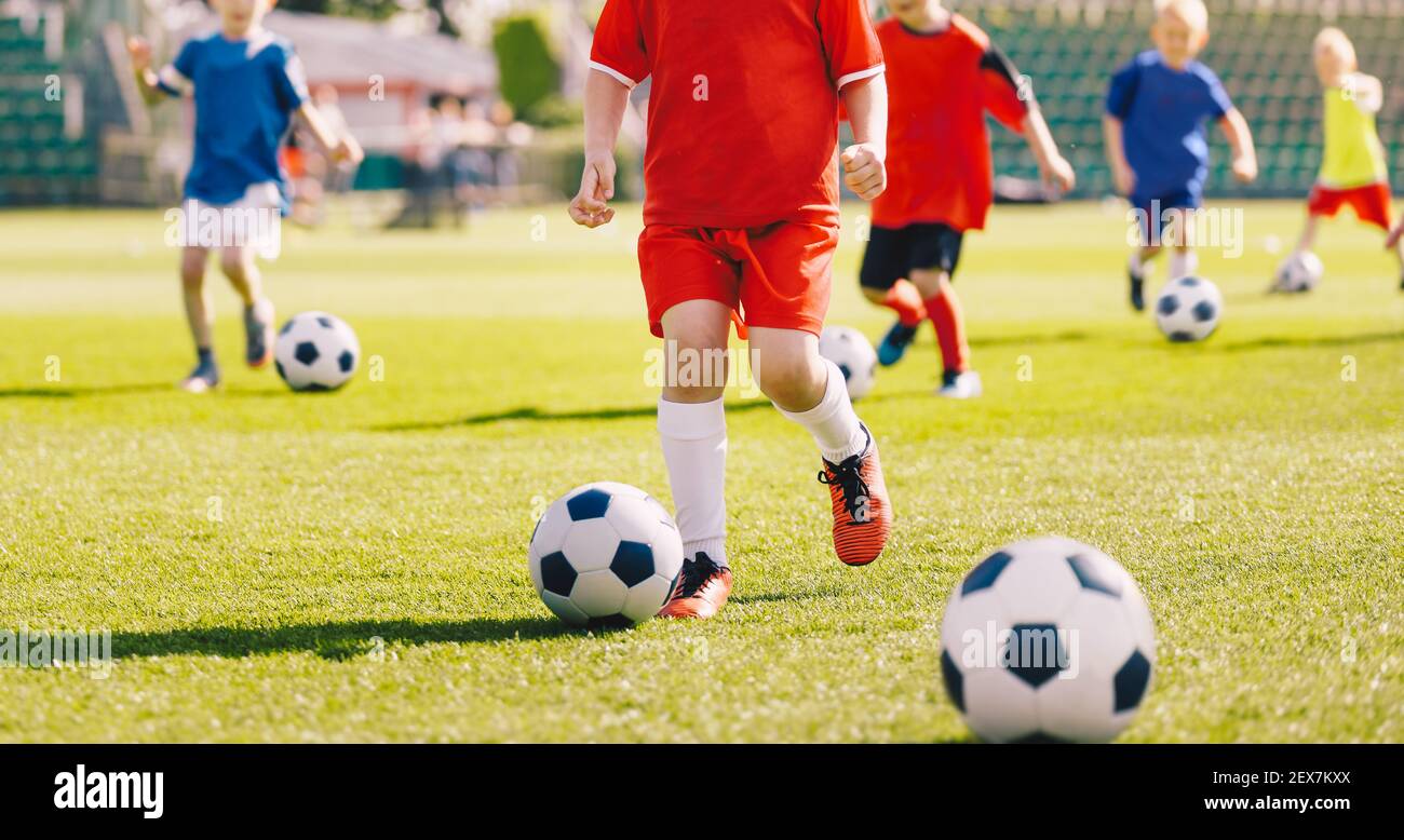 Sporty children on football summer camp. Kids practicing football on ...
