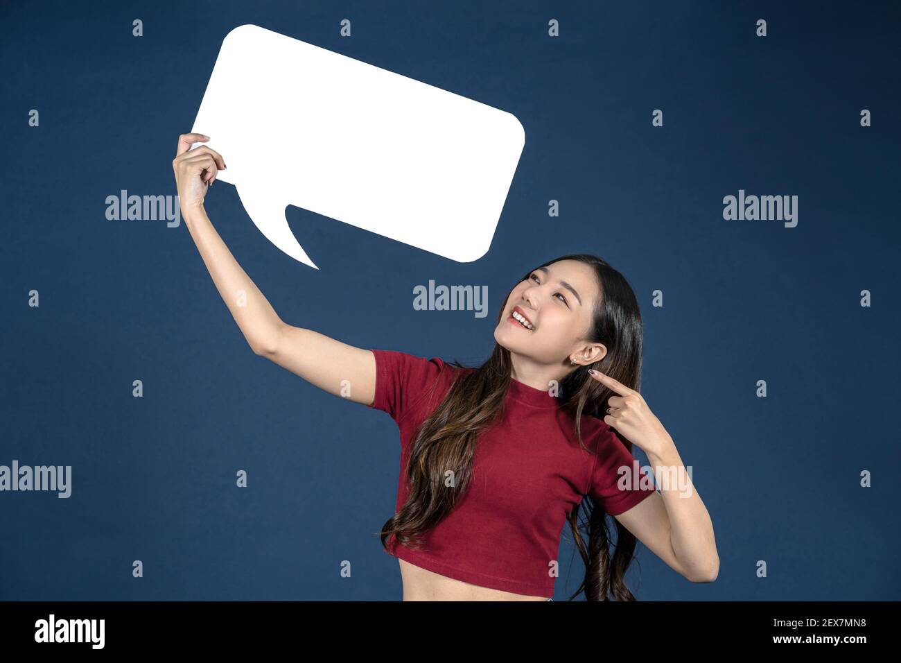 Happy young smiling Asian woman holding copy space empty message ...