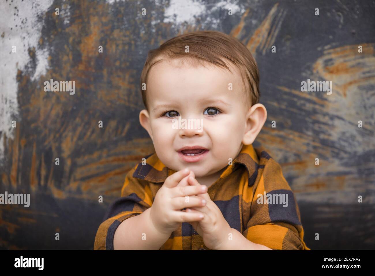 A baby boy eleven months old outdoors in the winter in a downtown ...