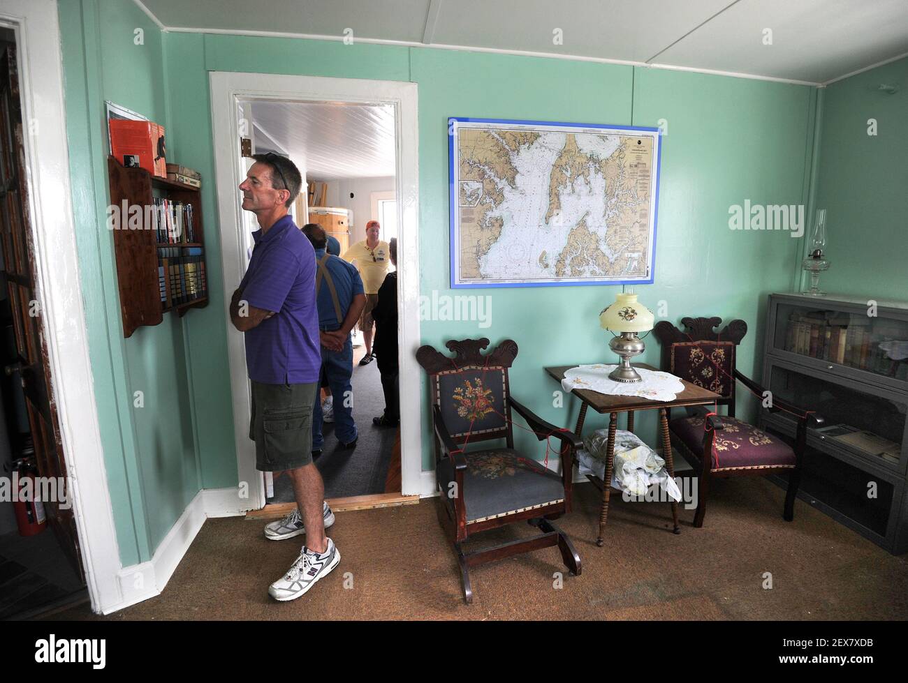 Jeff Short looks at the book collection in the Coast Guard equipment ...