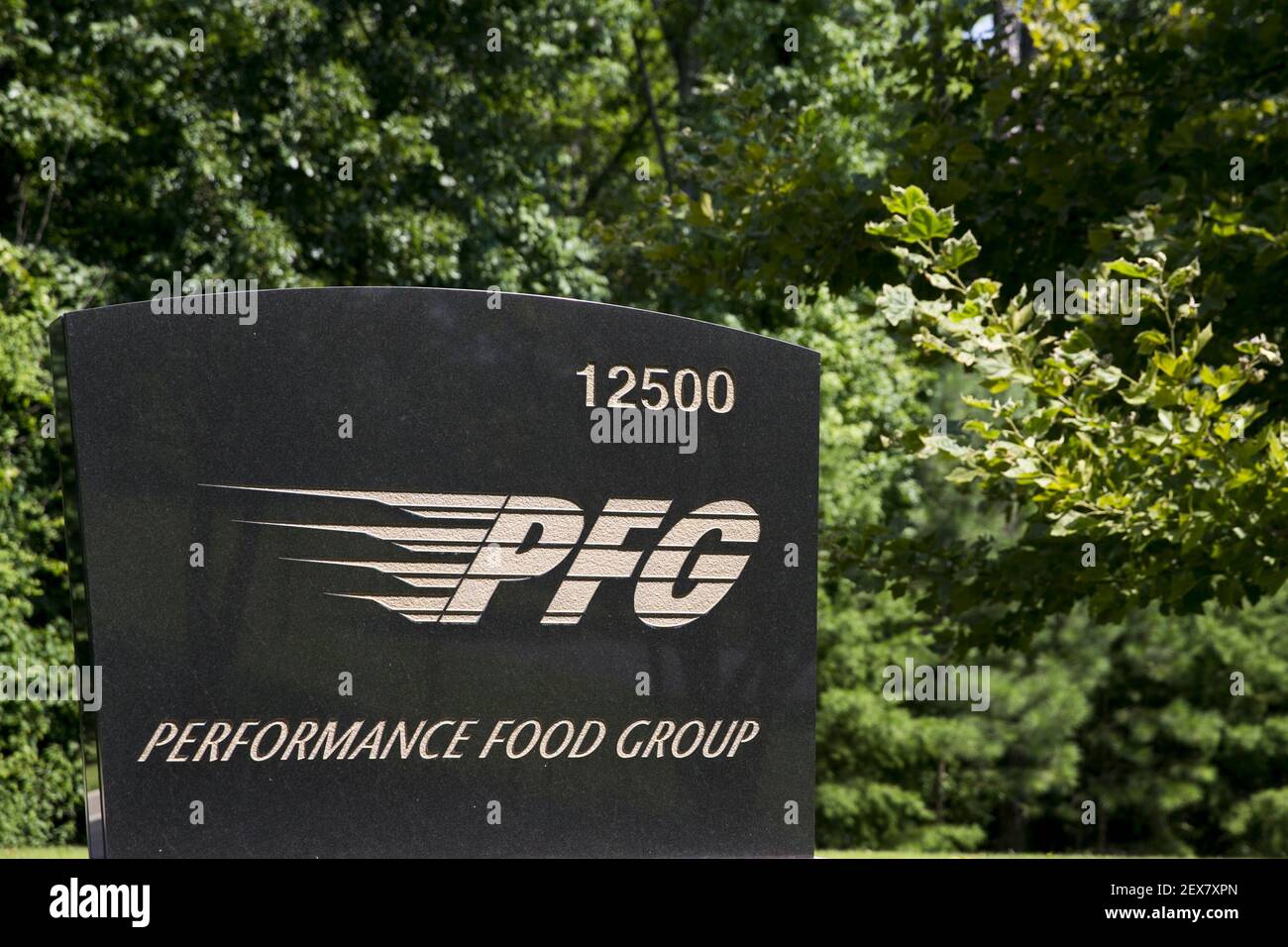 A logo sign outside of the headquarters of the Performance Food Group ...