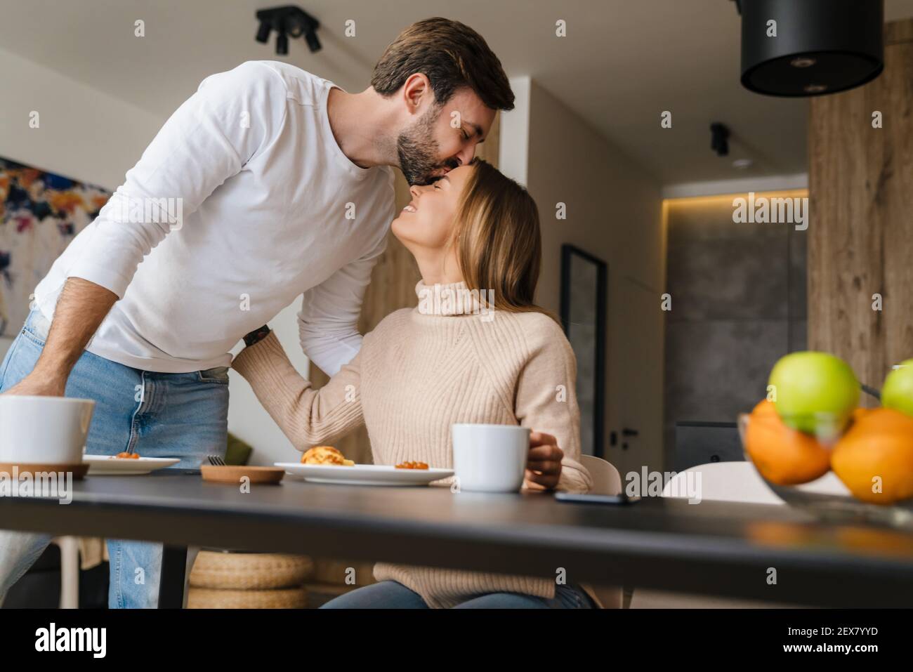 Young couple kissing eating breakfast hi-res stock photography and ...