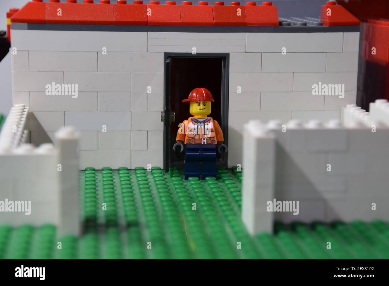 A Lego mini figure outside a door of a house built of Lego bricks Stock ...