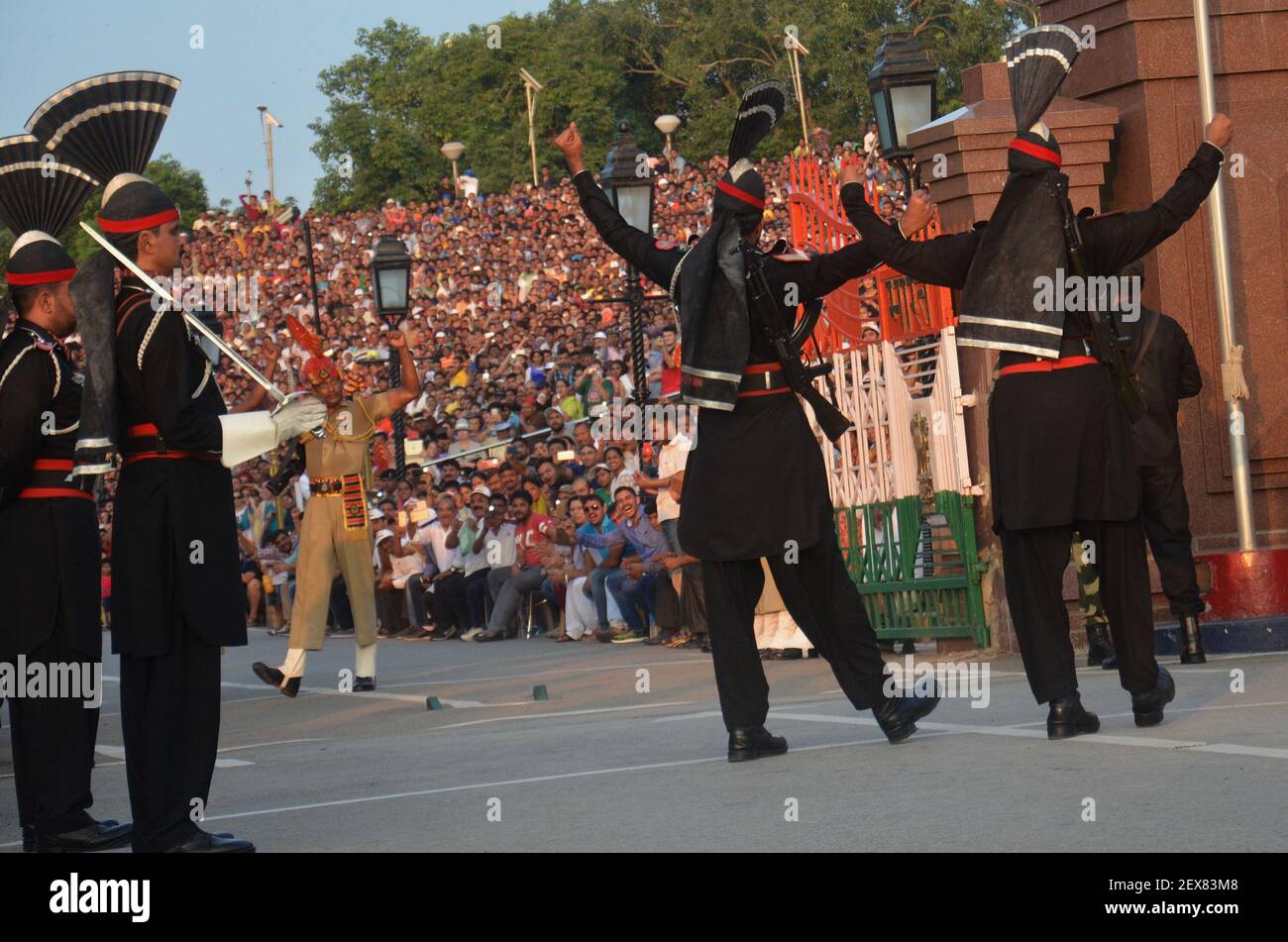 Pakistani rangers (wearing black uniforms) and Indian Border Security ...