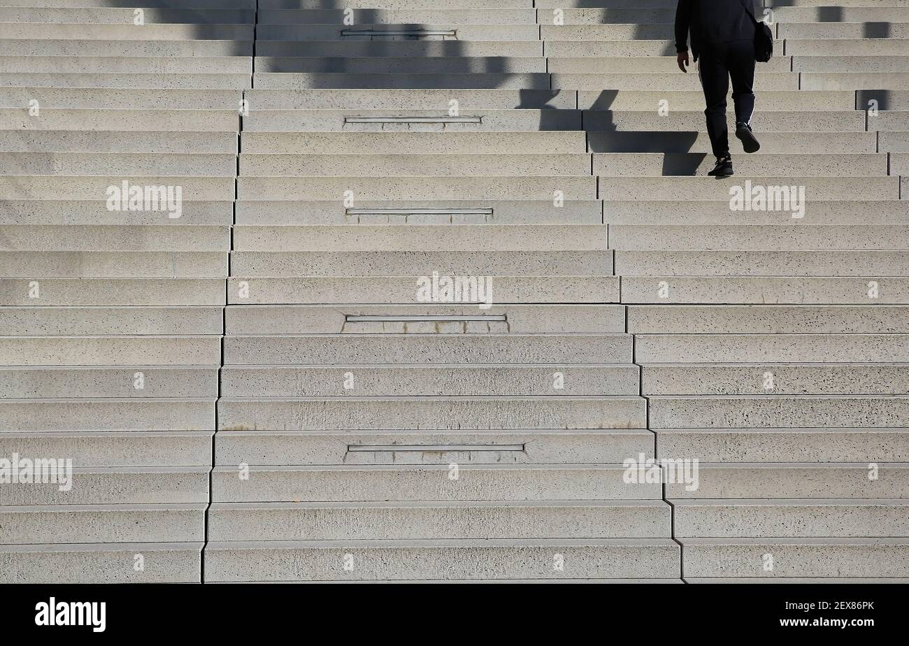 View on isolated steps with legs of one person walking upstairs Stock ...