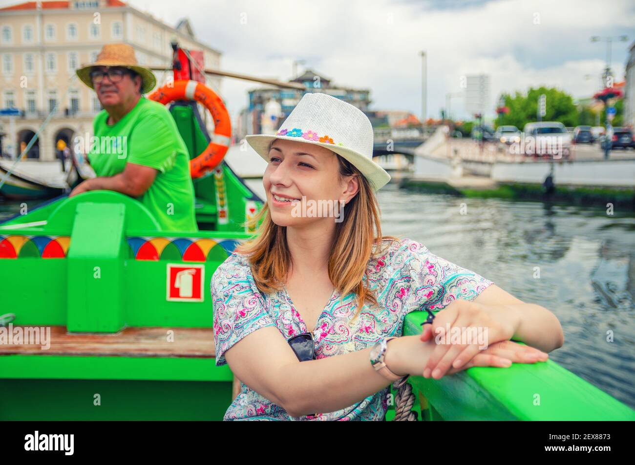 Young beautiful woman traveler with hat sailing in Moliceiro ...