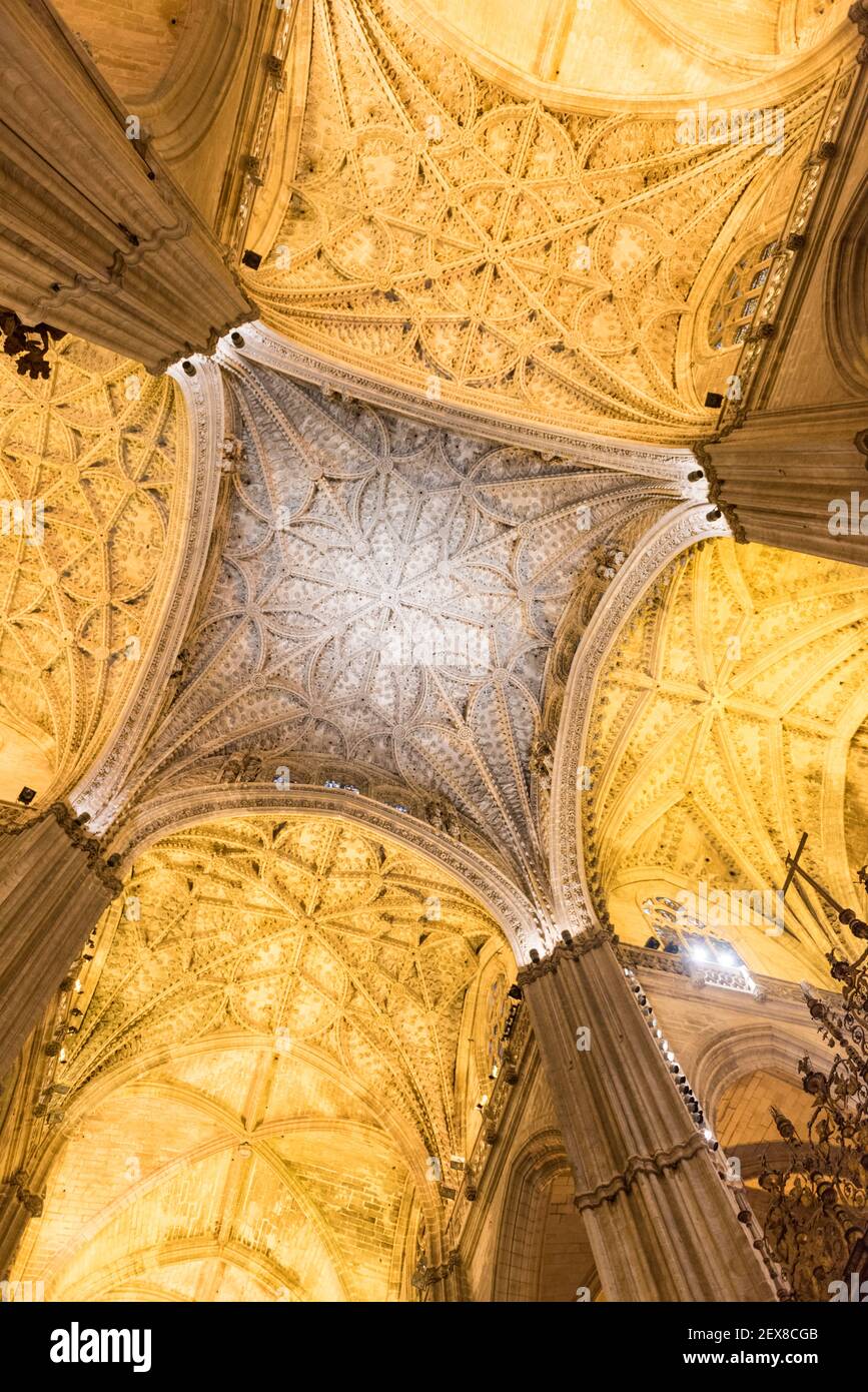 Ornate windows and celings in the Seville Cathedral Spain Stock Photo ...