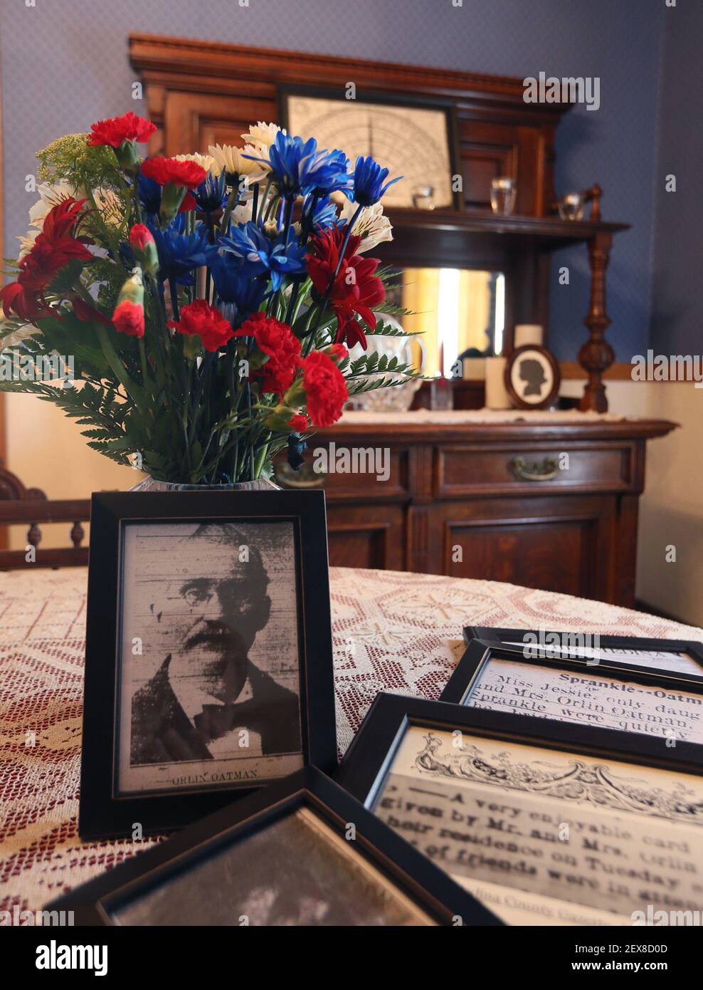 A framed photo of the home's original owner, Orlin Oatman, sits on the ...