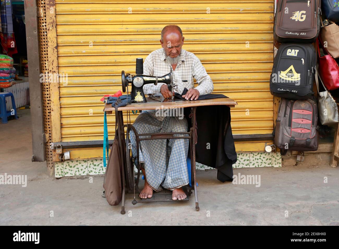 Dhaka, Bangladesh - March 04, 2021: Md. Sultan has been sewing on the sidewalk of Badda in Dhaka ...