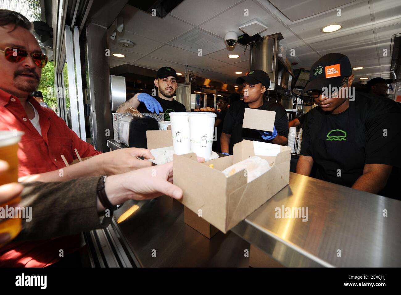 Customers pick up their order at the Shake Shack counter as Shake Shack ...