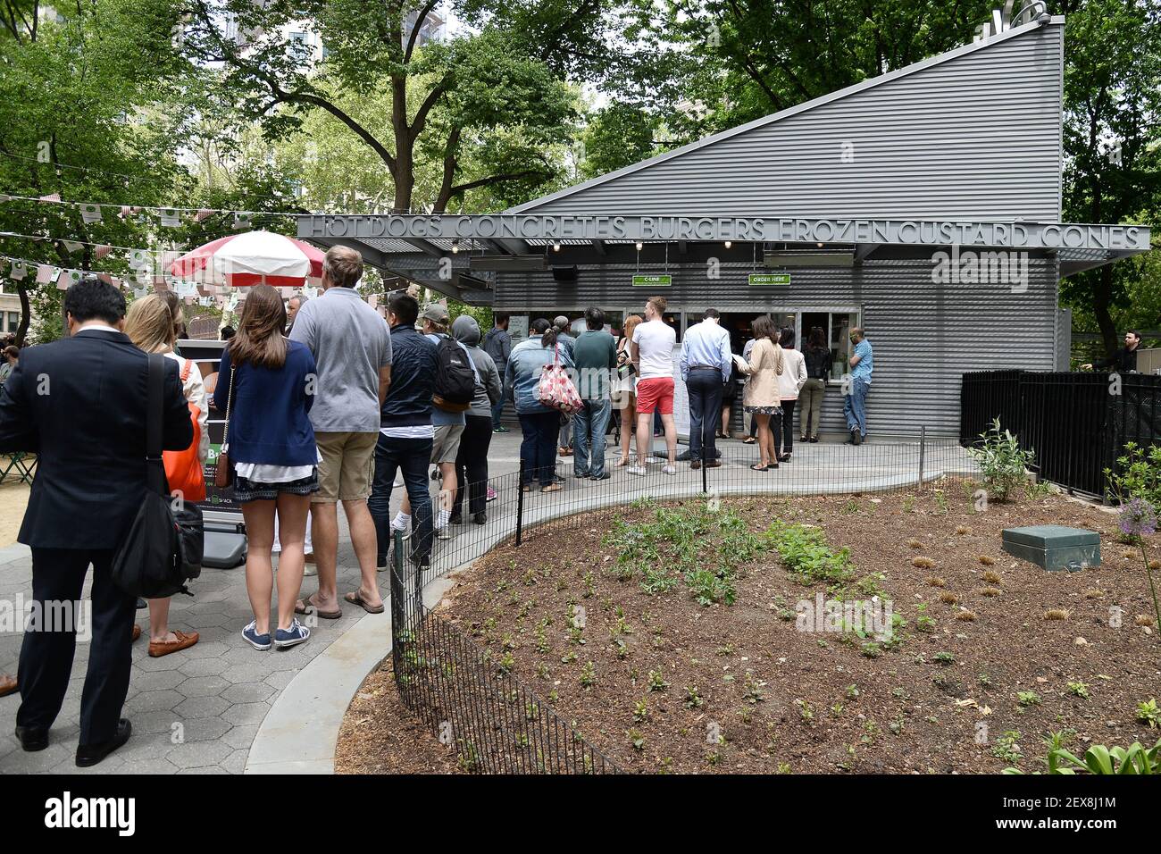A long line of customers wait to place their orders as Shake Shack ...