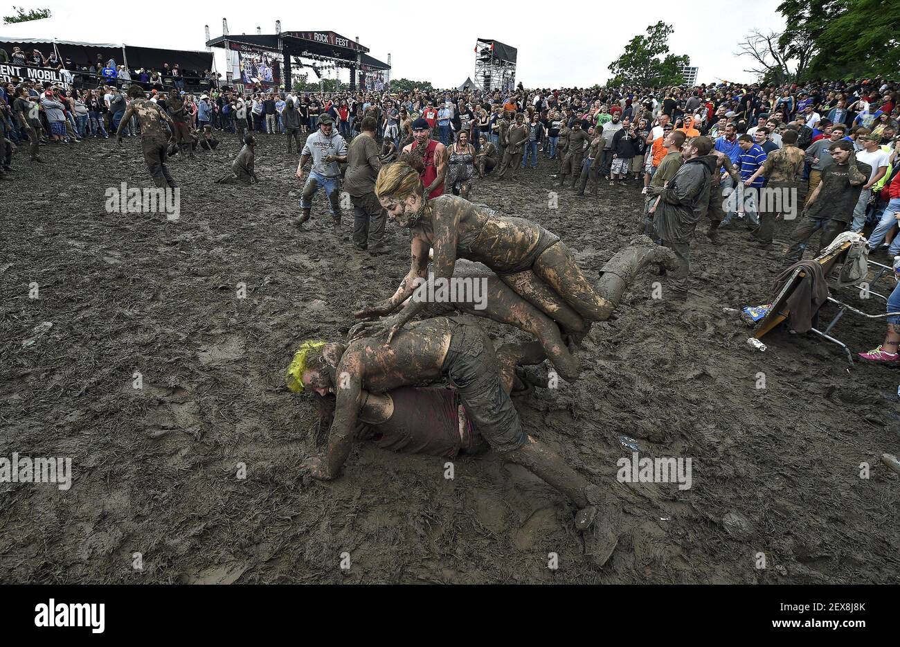 A muddy hillside became the mud wrestling spot for spectators during ...