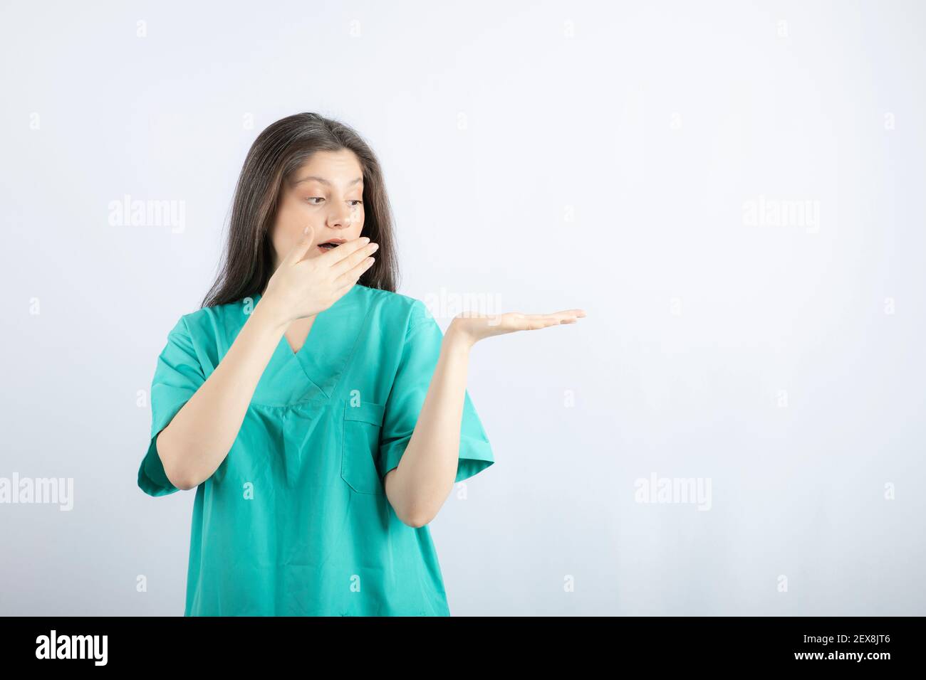 Shocked medical worker holding her hand up Stock Photo - Alamy