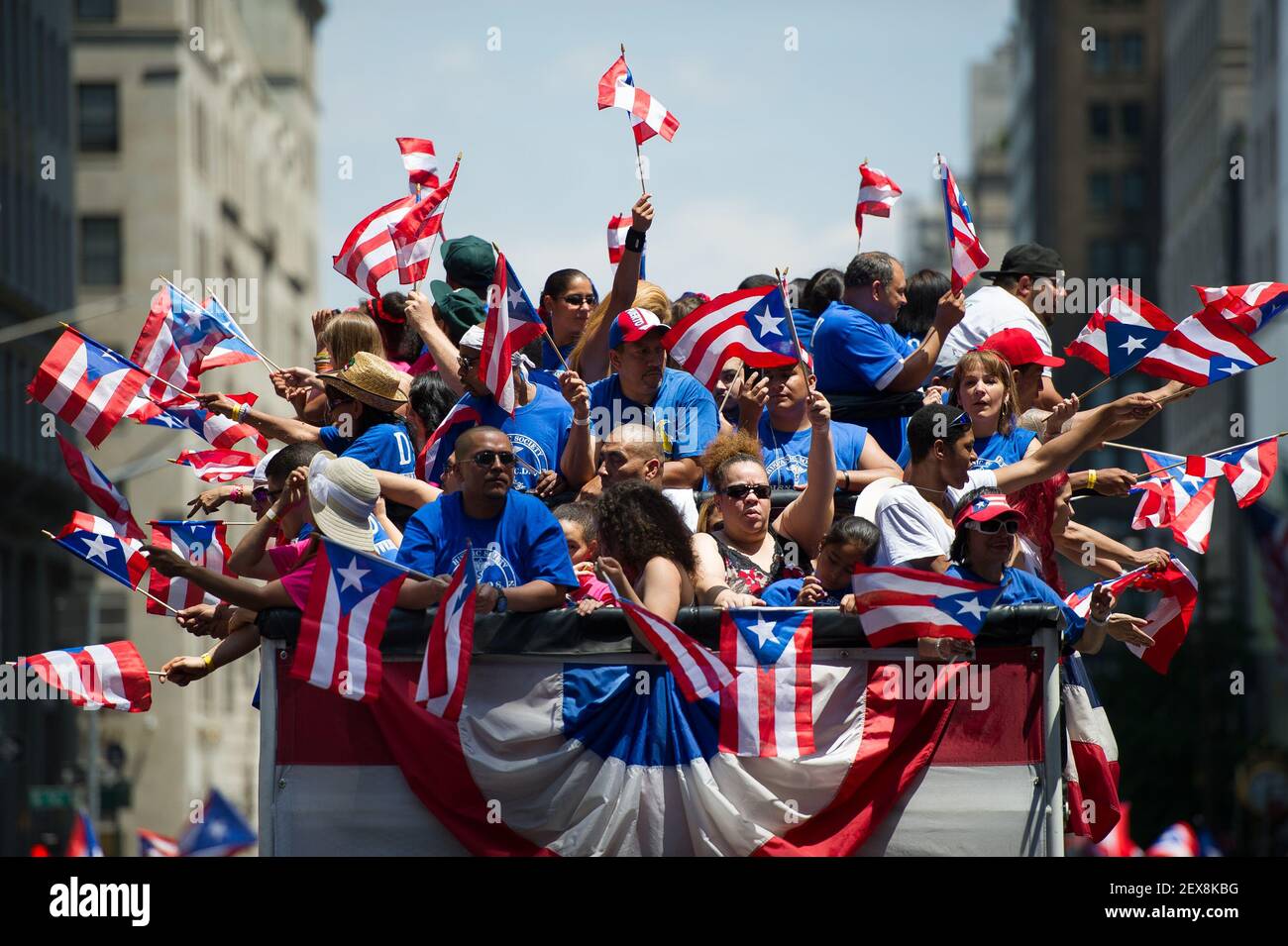 Parade-goers wave the Puerto Rican flag on their float during the 58th ...