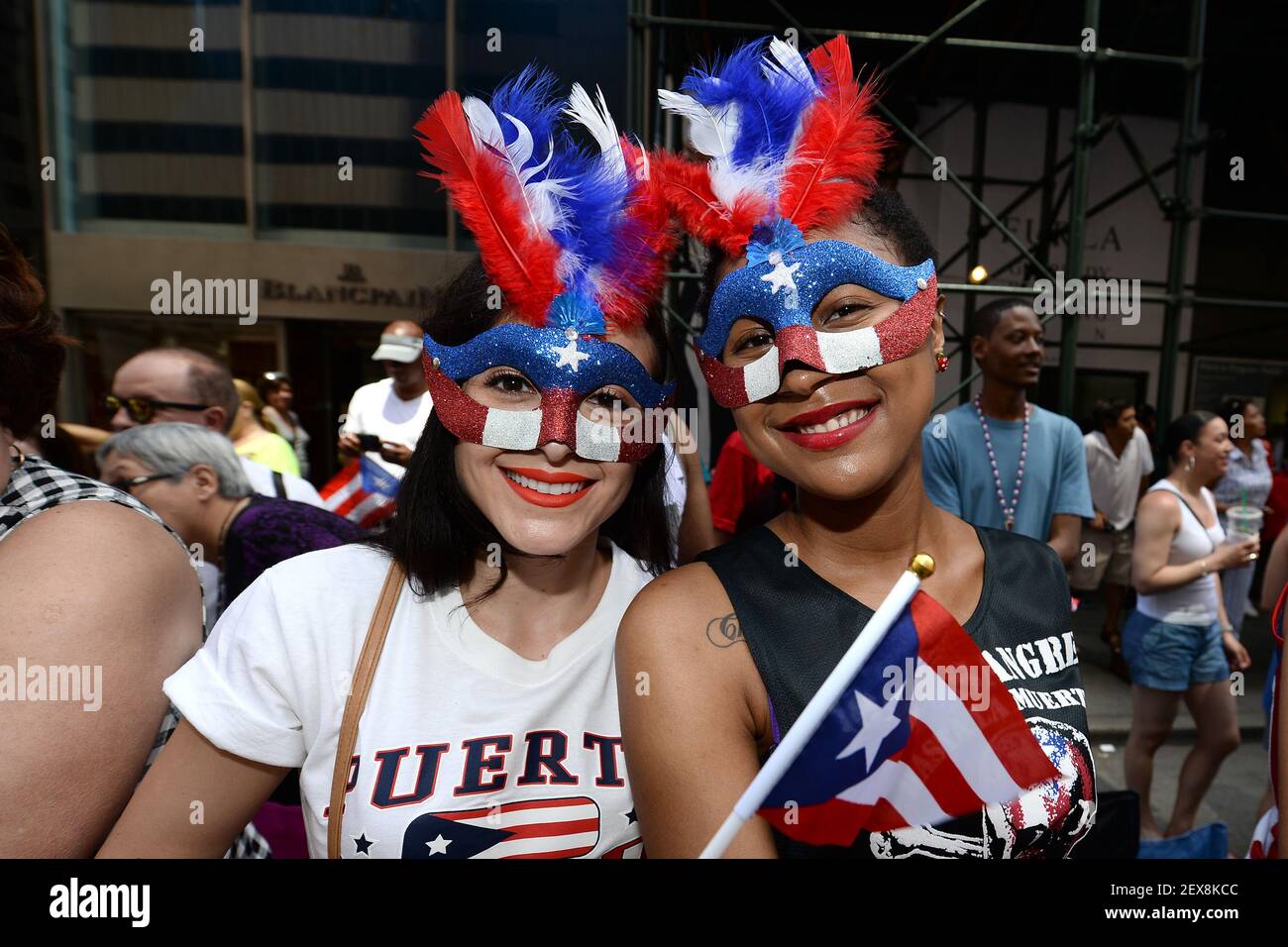 Specttors wearing color masks watch the 58th Annual National Puerto ...