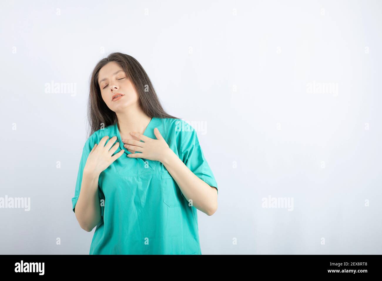 Nurse felling tired and sick on white background Stock Photo - Alamy