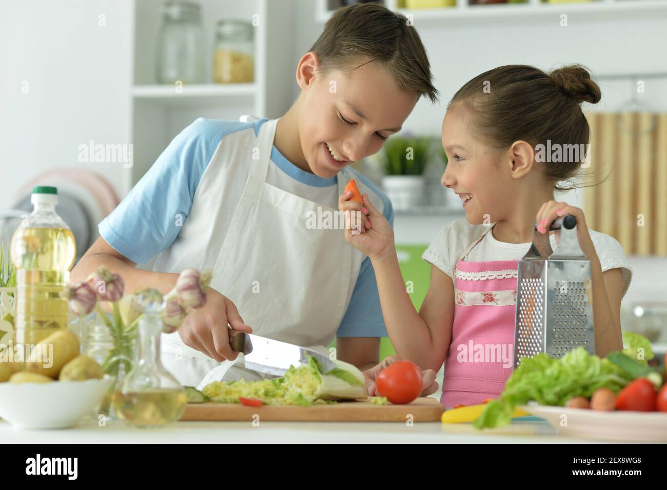 Cute brother and sister cooking together in kitchen Stock Photo - Alamy