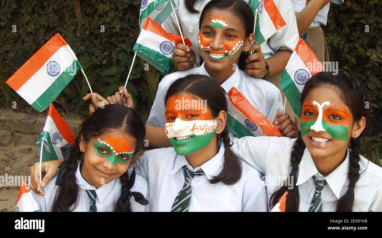 School children paint their faces with the Indian flag painted to ...
