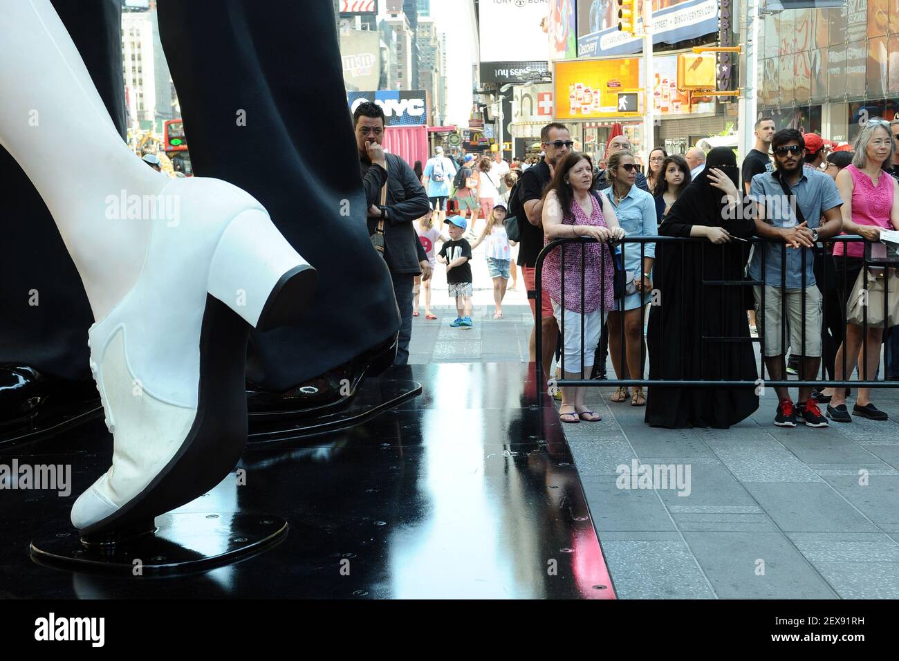 At the food of 25-foot statue, a woman of muslim faith wears a niqab ...