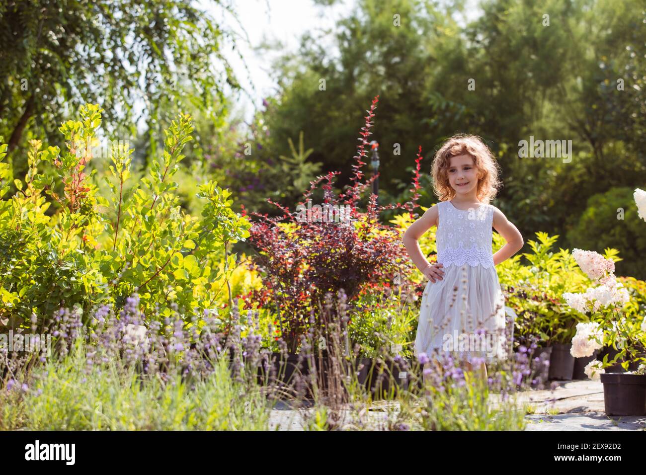 Little girls dancing among wonderful blooming flowers Stock Photo - Alamy